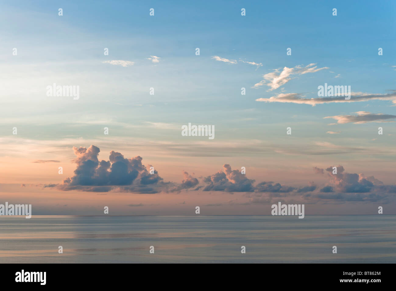 View of Calm Seas and Distant Clouds at Sunset from the Deck of a ...