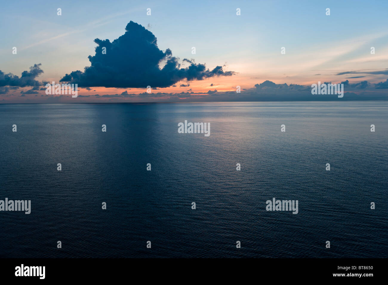View of Calm Seas and Distant Clouds at Sunset from the Deck of a ...