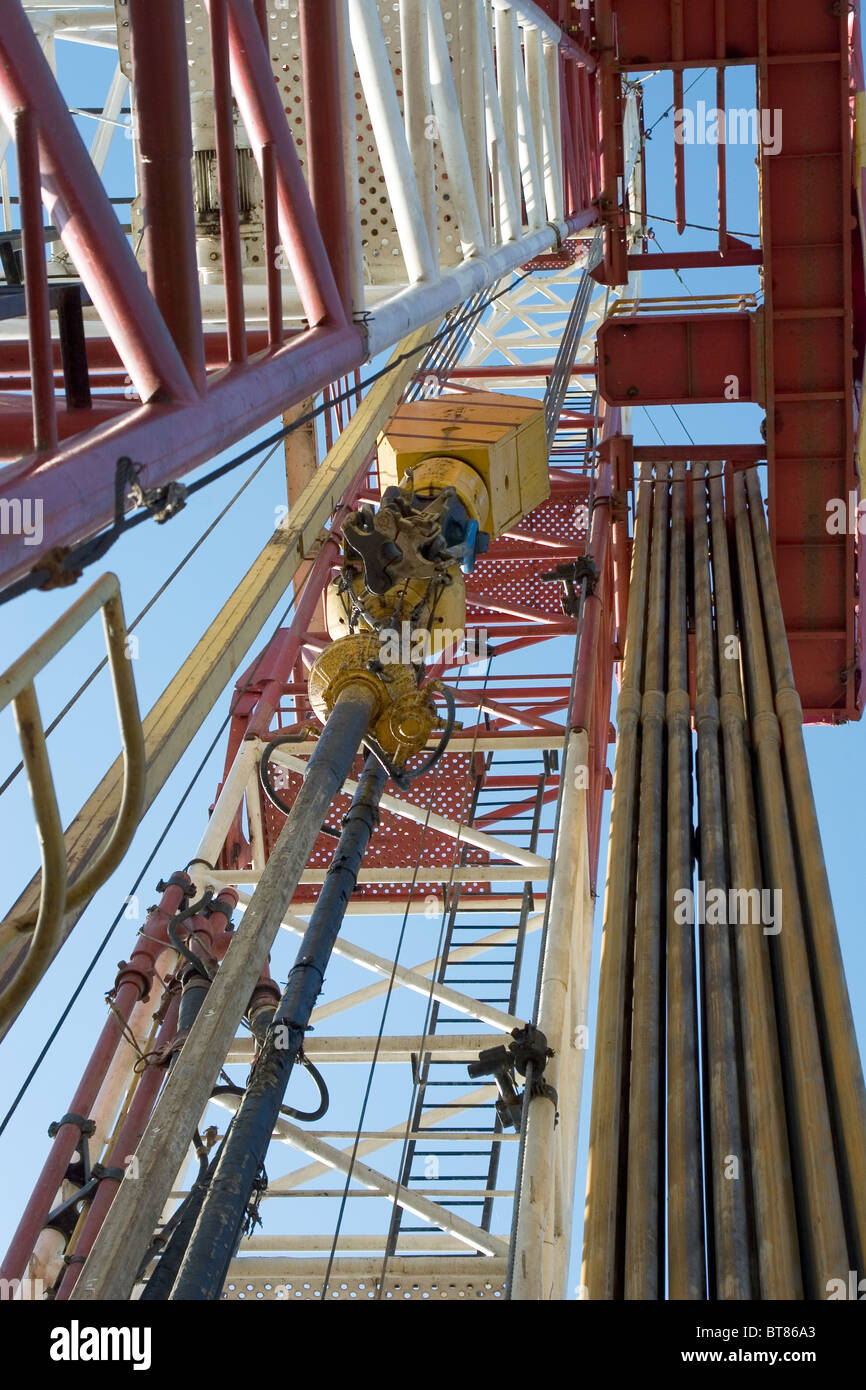 Onshore oil and gas exploration site. View to top of derrick with ...