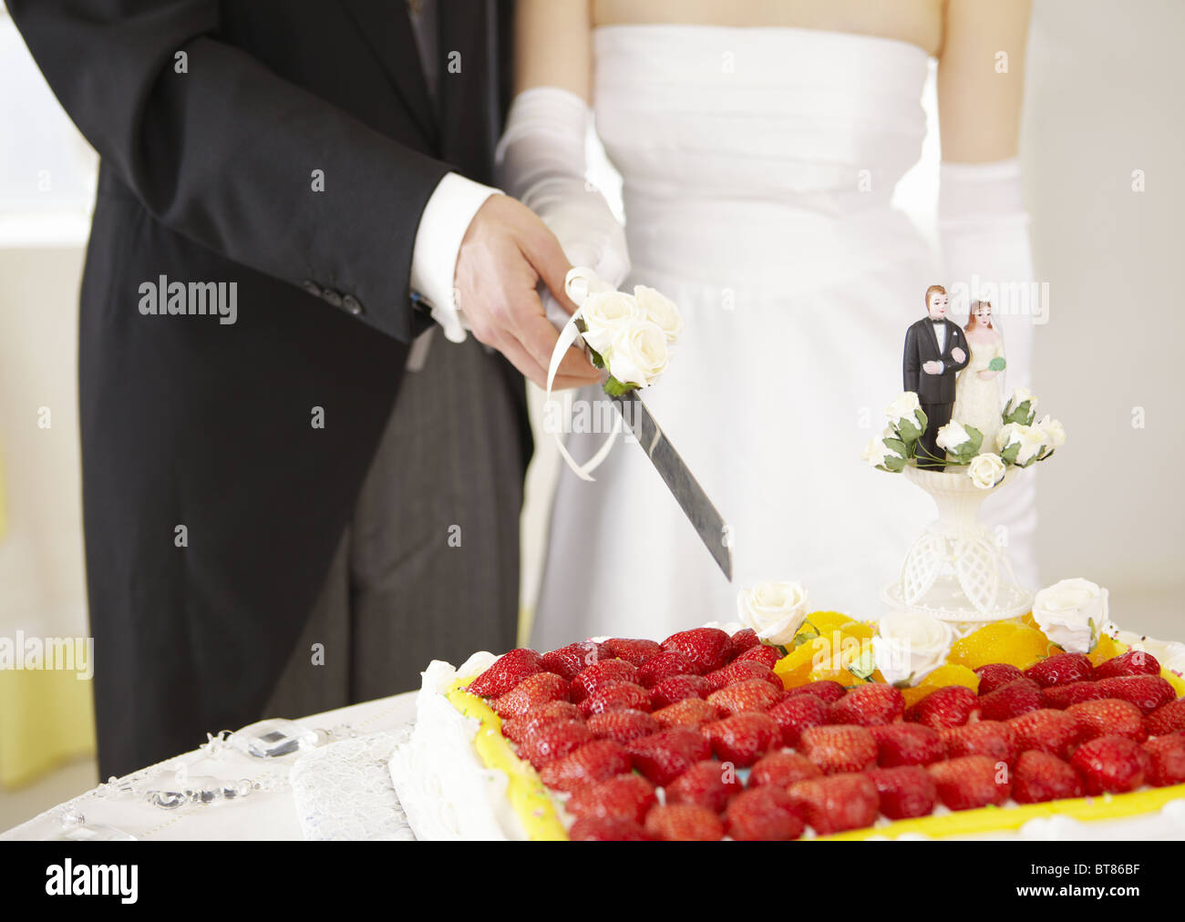 Bride and groom cutting wedding cake Stock Photo - Alamy