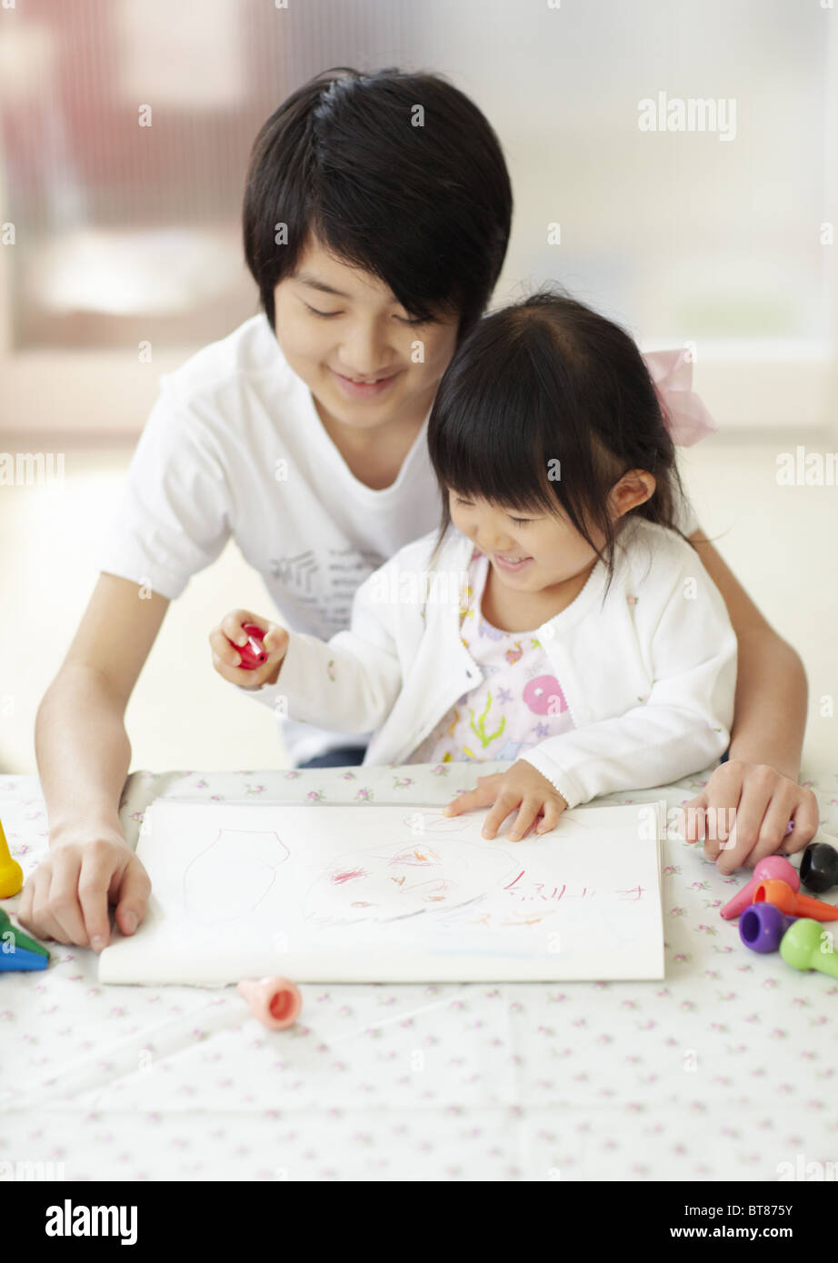 Brother and sister drawing Stock Photo - Alamy