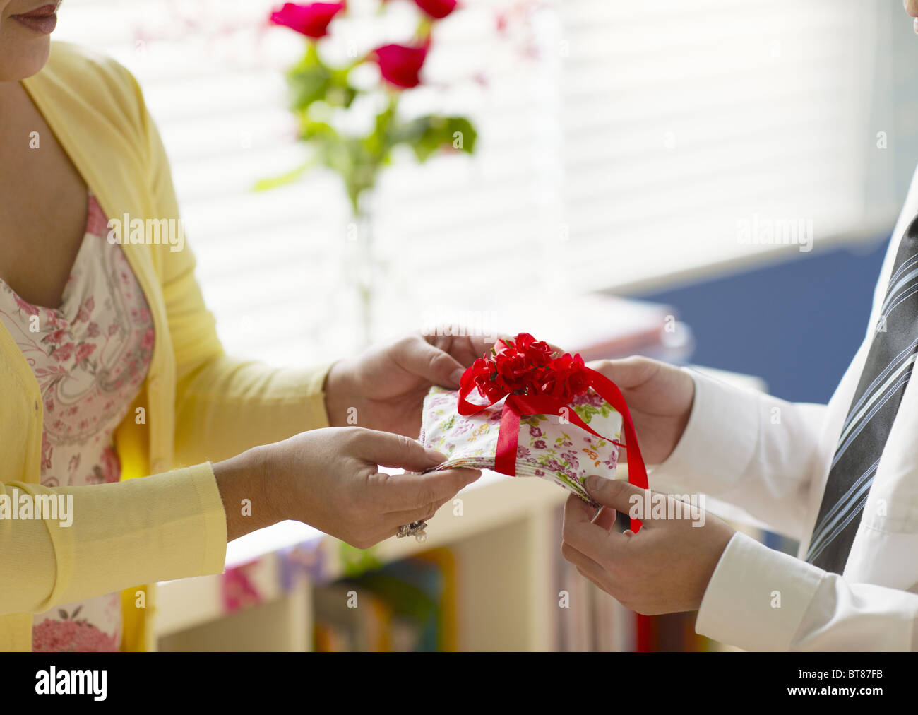 Close up of hands giving a gift Stock Photo - Alamy