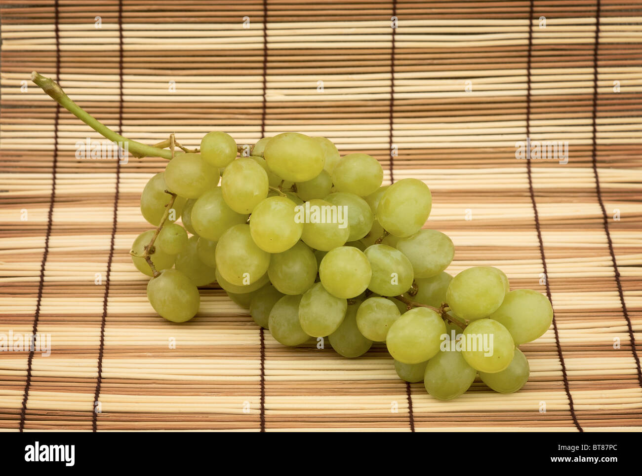 Green grapes on the wooden mat background Stock Photo - Alamy