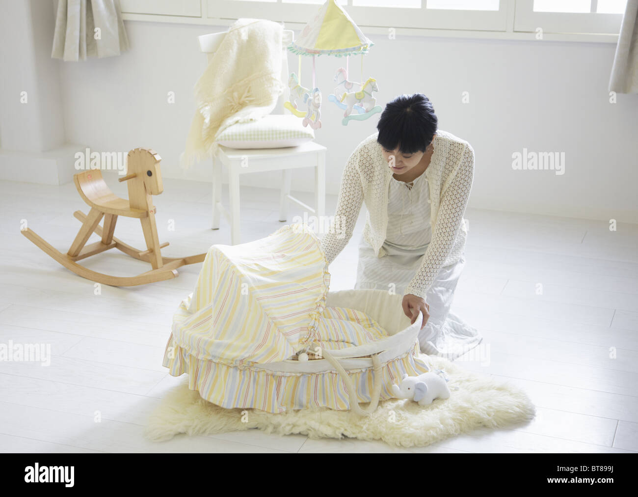 Cradle and mother Stock Photo - Alamy