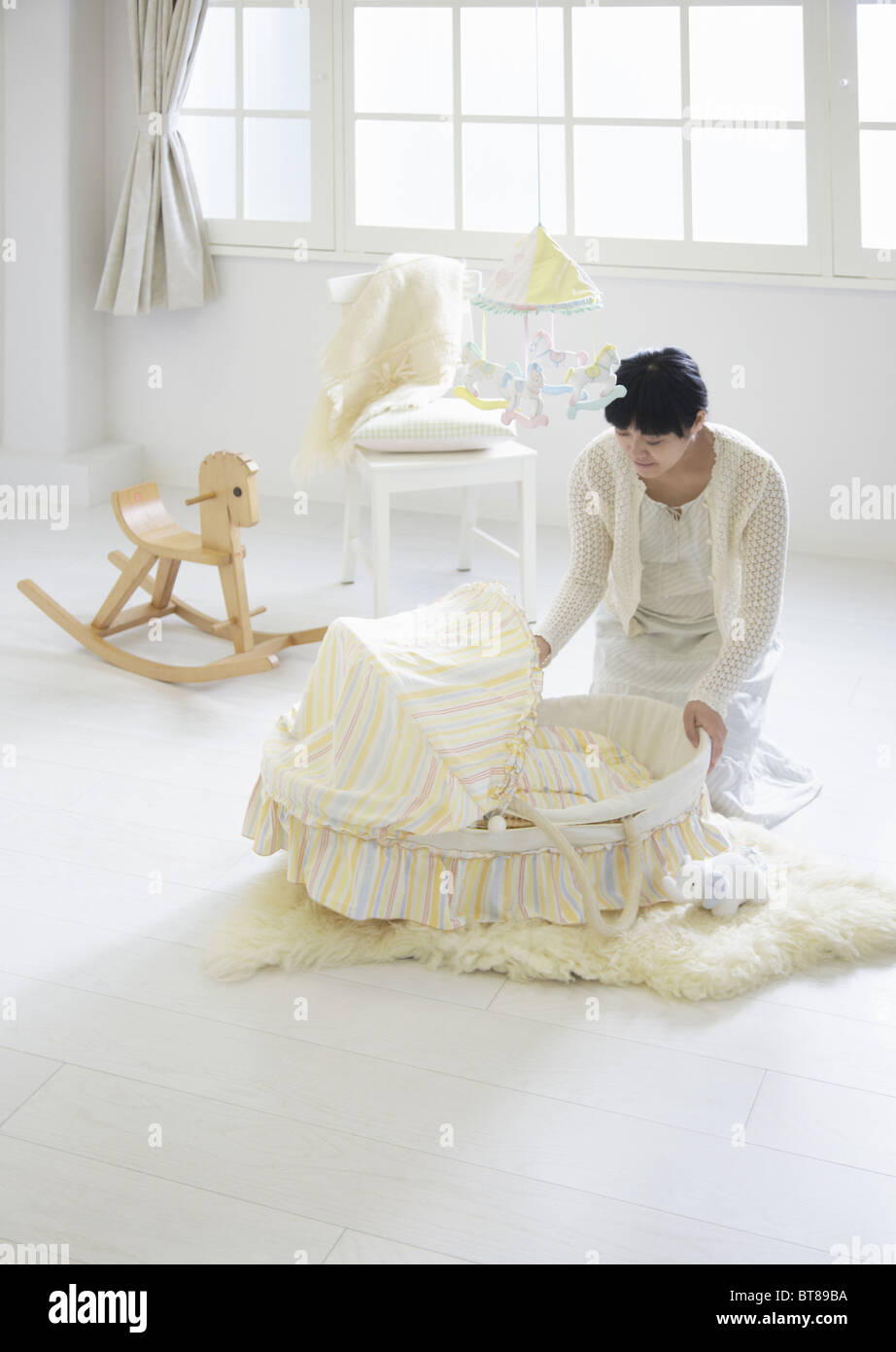 Cradle and mother Stock Photo - Alamy