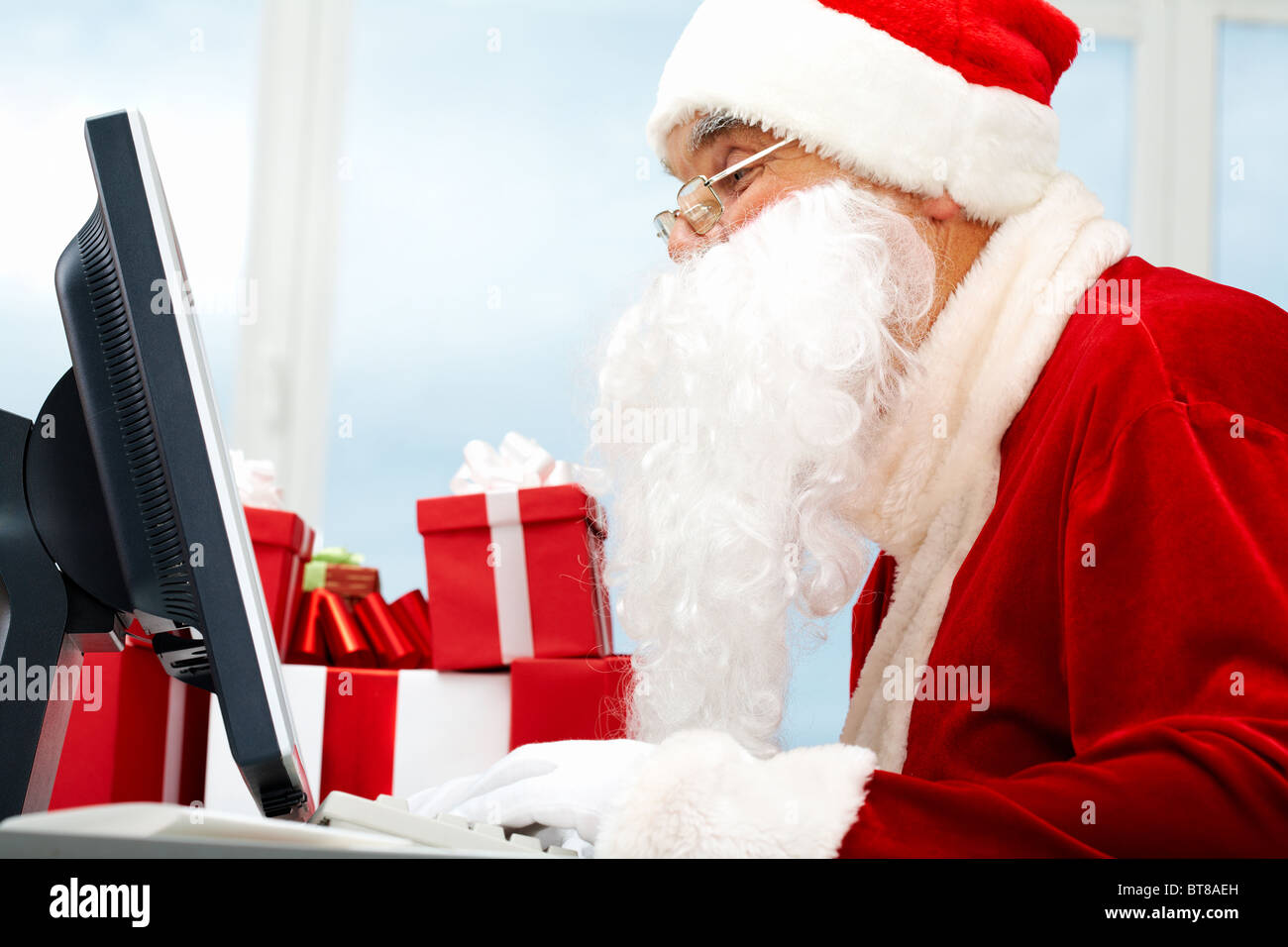 Portrait of Santa Claus in front of computer monitor Stock Photo - Alamy