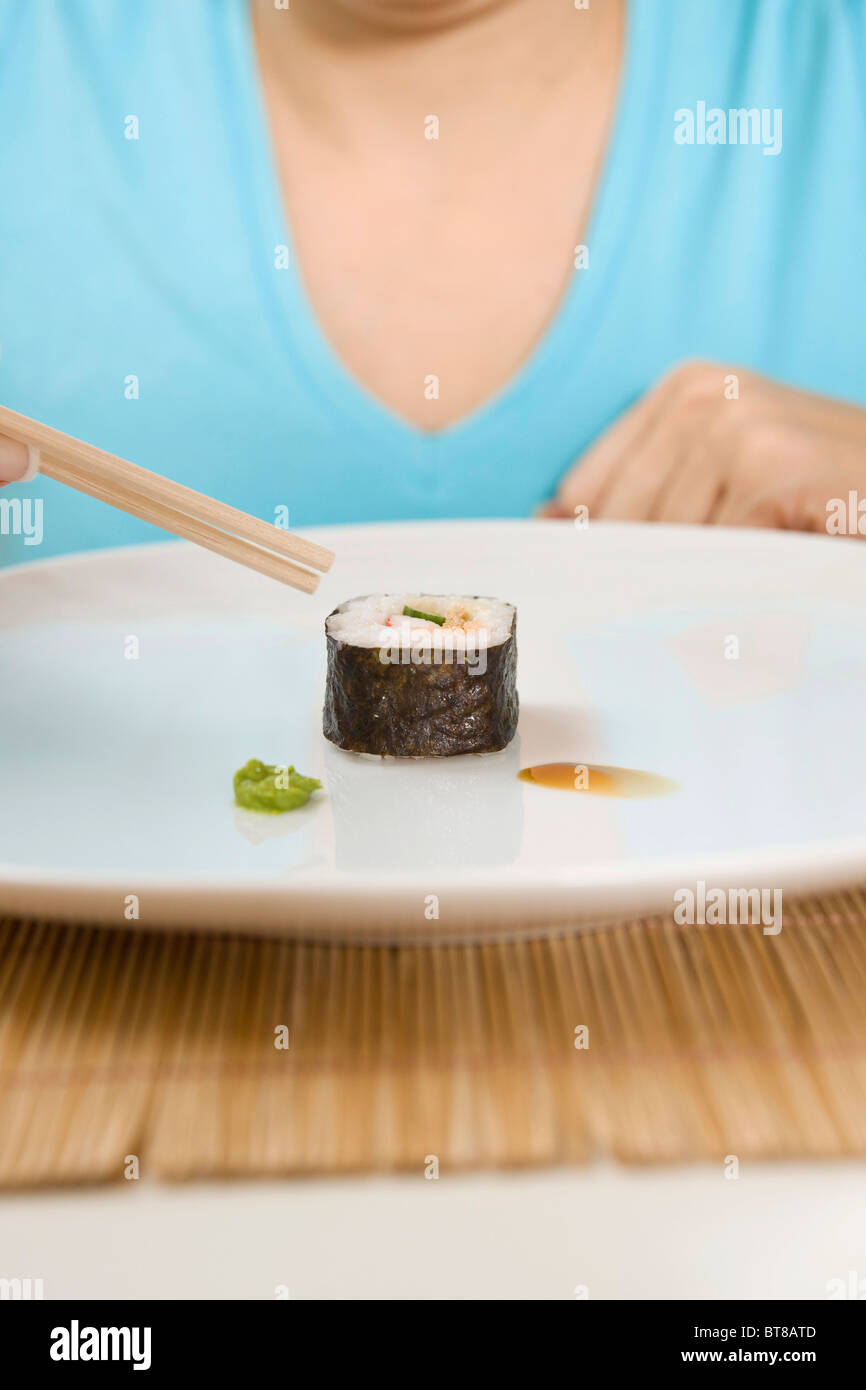 Section of a woman, eating sushi Stock Photo - Alamy