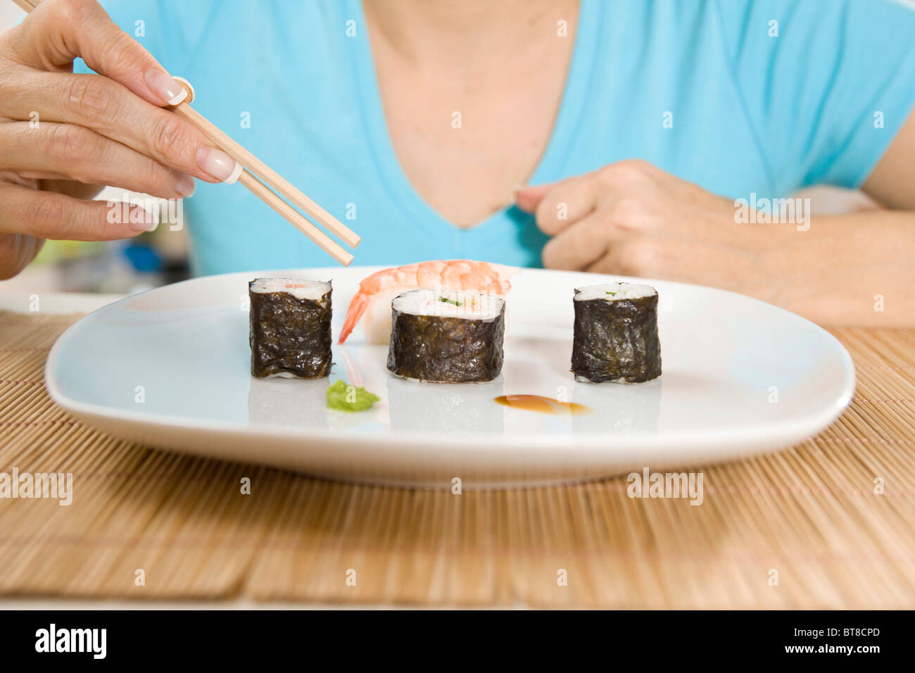 Section of a woman, eating sushi Stock Photo - Alamy