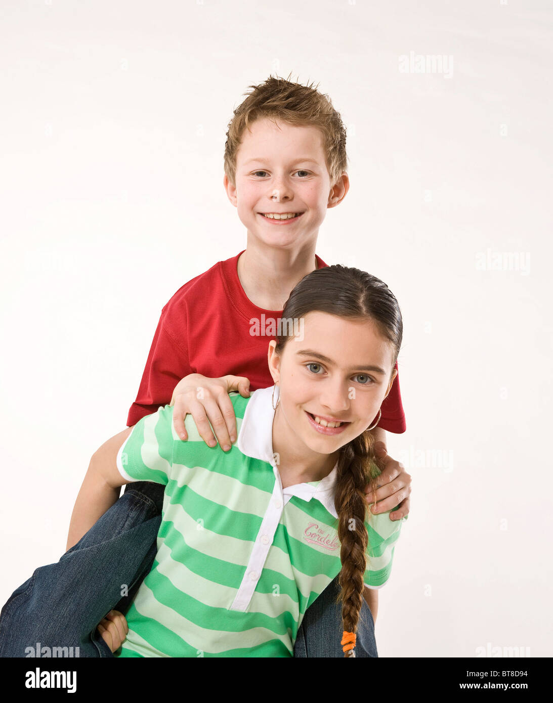 Girl smiling while giving a boy a piggyback ride Stock Photo - Alamy