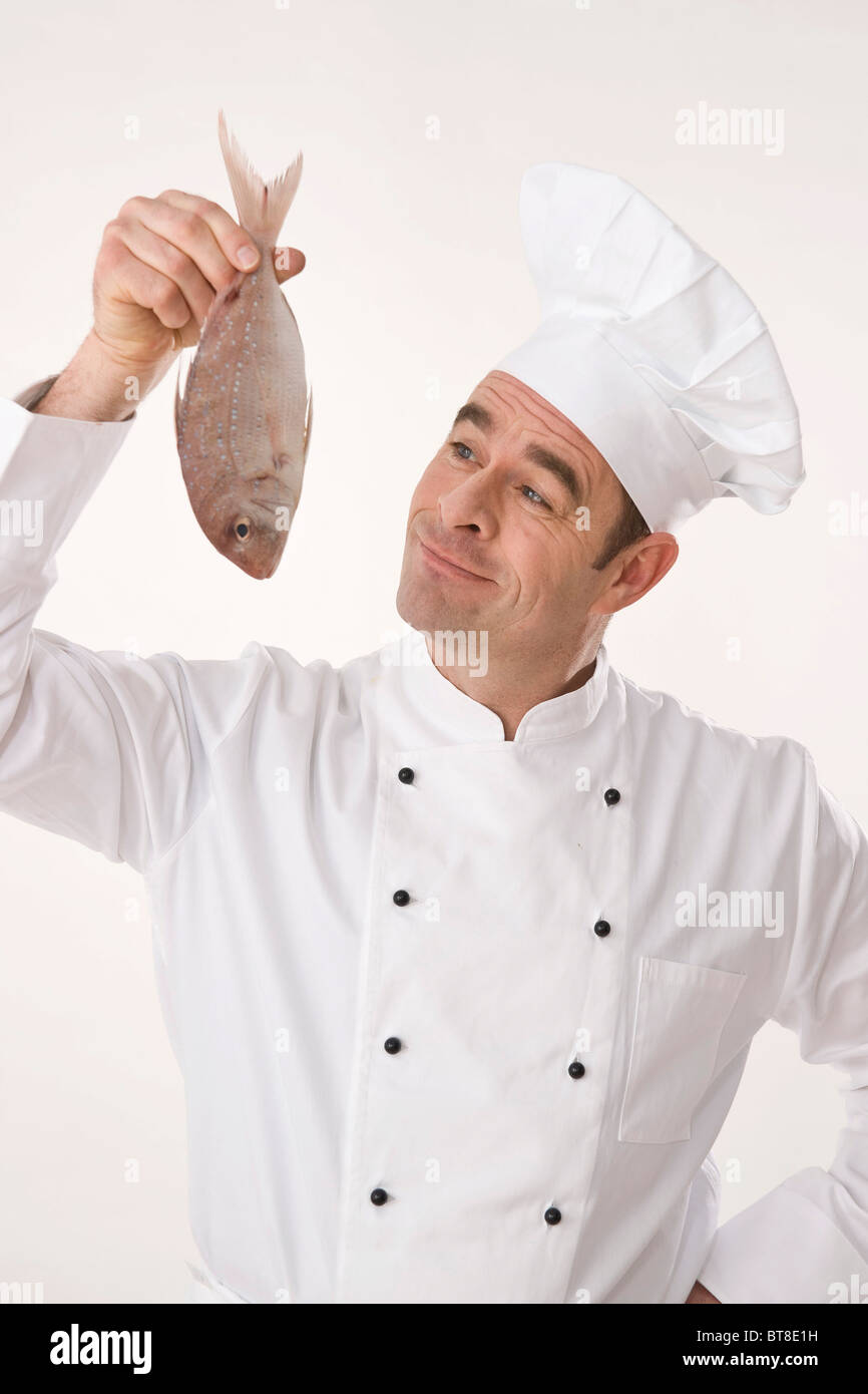 Cook holding a Gilthead Bream Stock Photo - Alamy