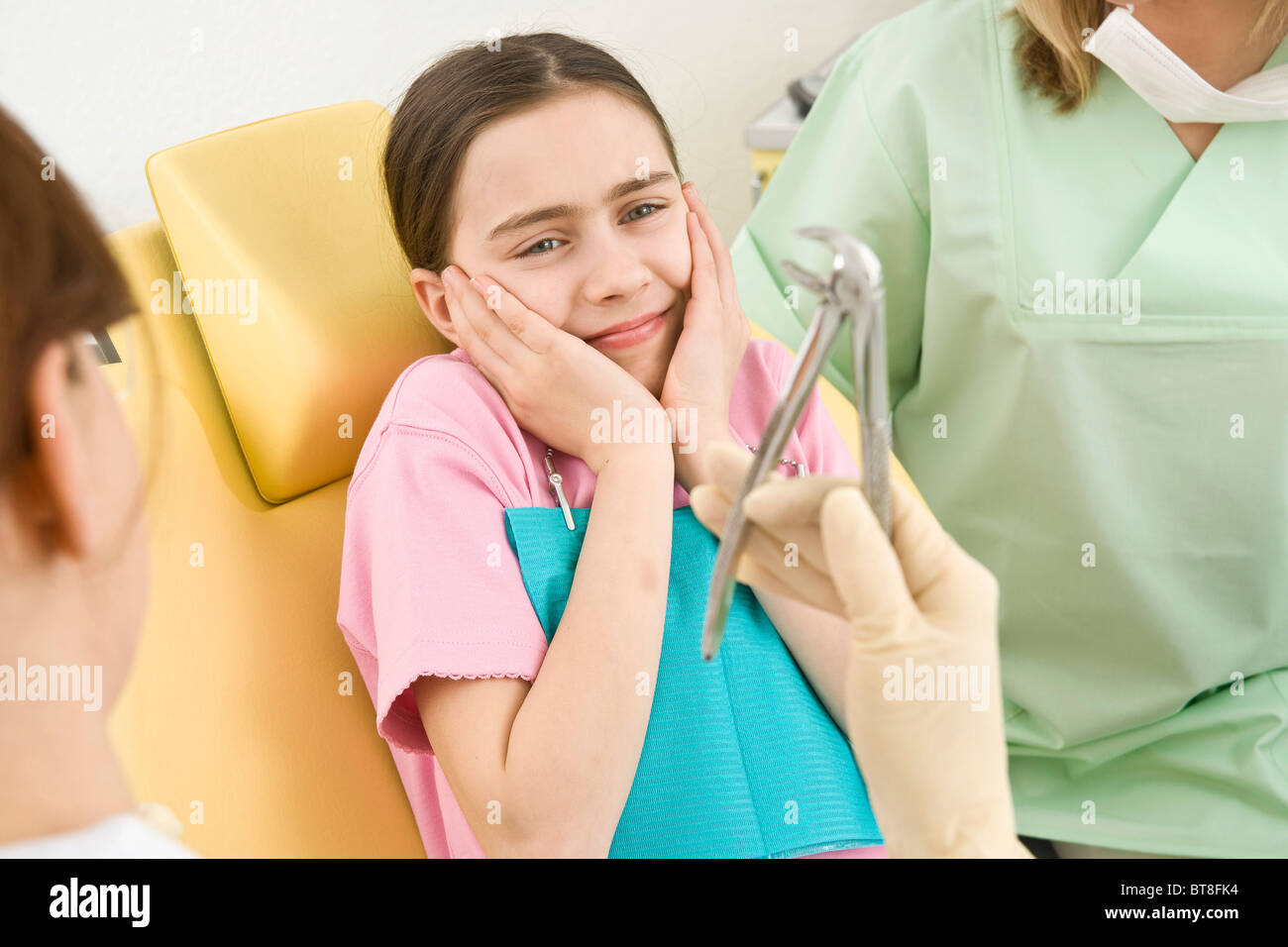 Girl, scared of a tooth being pulled Stock Photo - Alamy