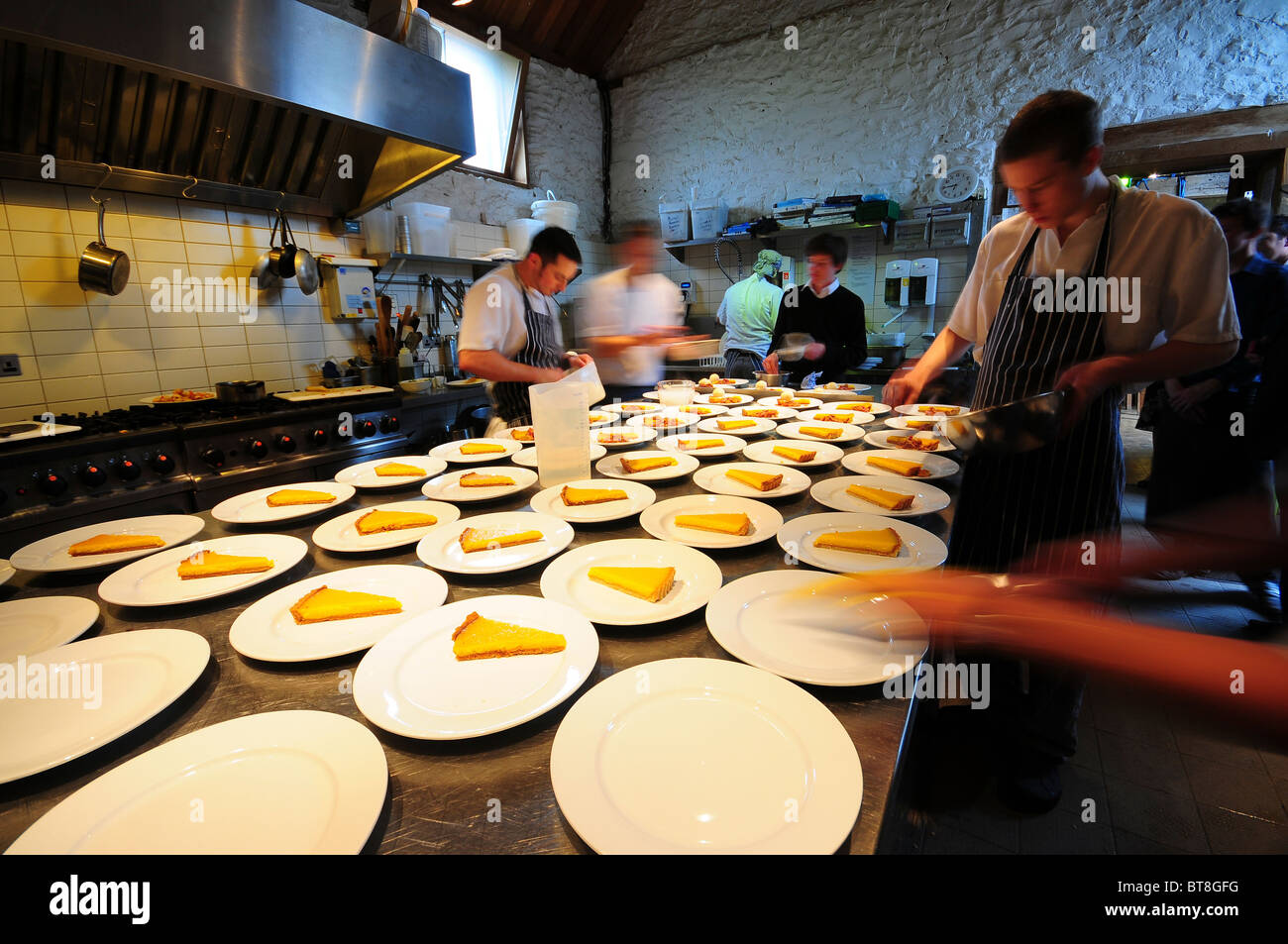 Chefs preparing sweet course in kitchen. May 2010 UK Stock Photo - Alamy