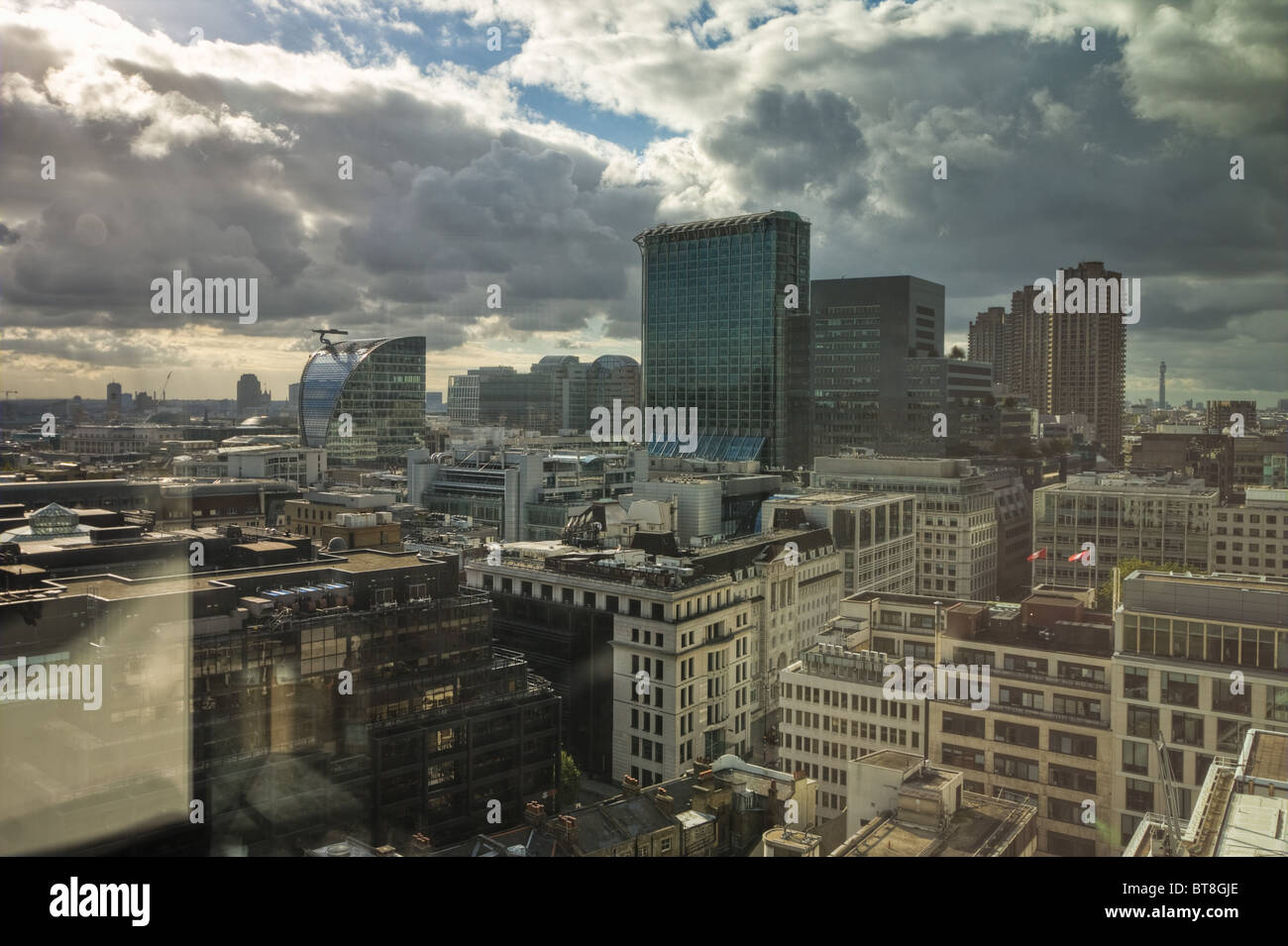 city of london skyline seen through the glass window of an office in ...