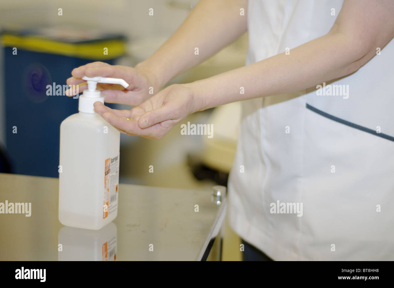 Nurse using an anti bacterial hygiene hand wash in a hospital ward ...