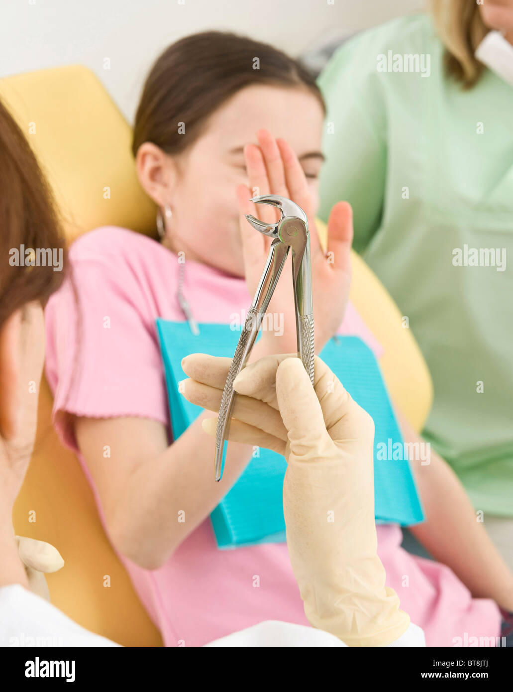 Girl, scared of a tooth being pulled Stock Photo - Alamy