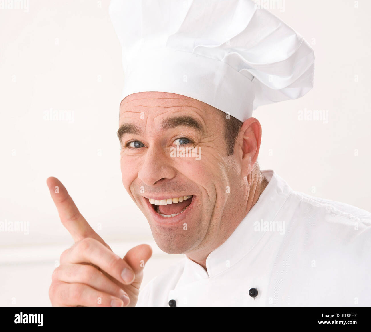 Cook gesticulating, laughing Stock Photo - Alamy