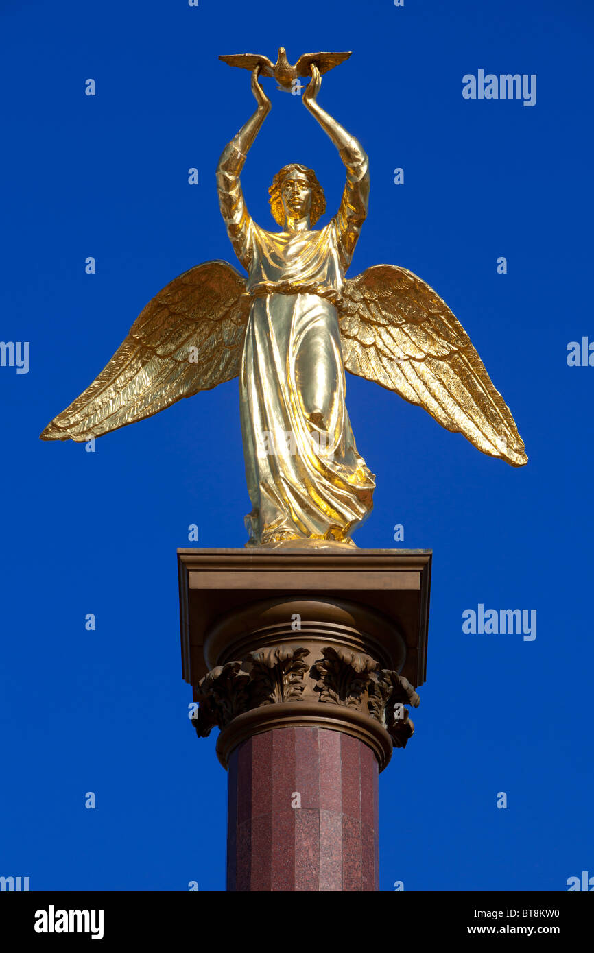 Golden statue of an angel holding a peace dove at the Fallen Monument ...