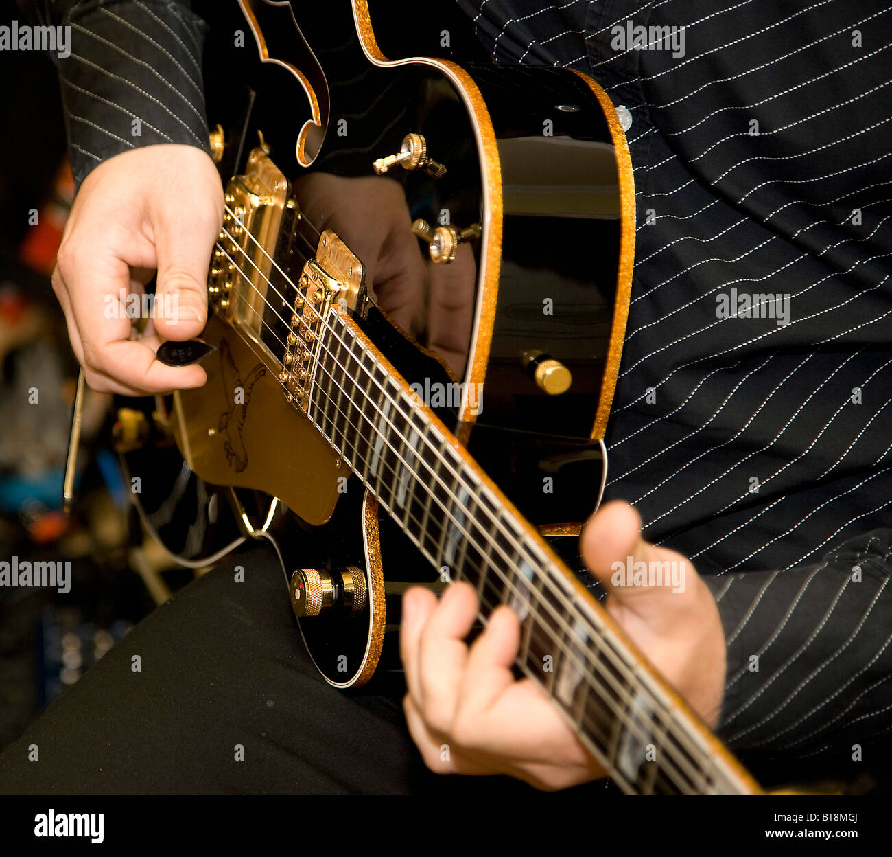 Guitar being played in a band Stock Photo - Alamy