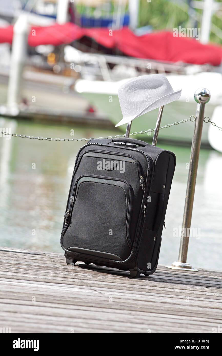Suitcase at the yacht harbor Stock Photo - Alamy