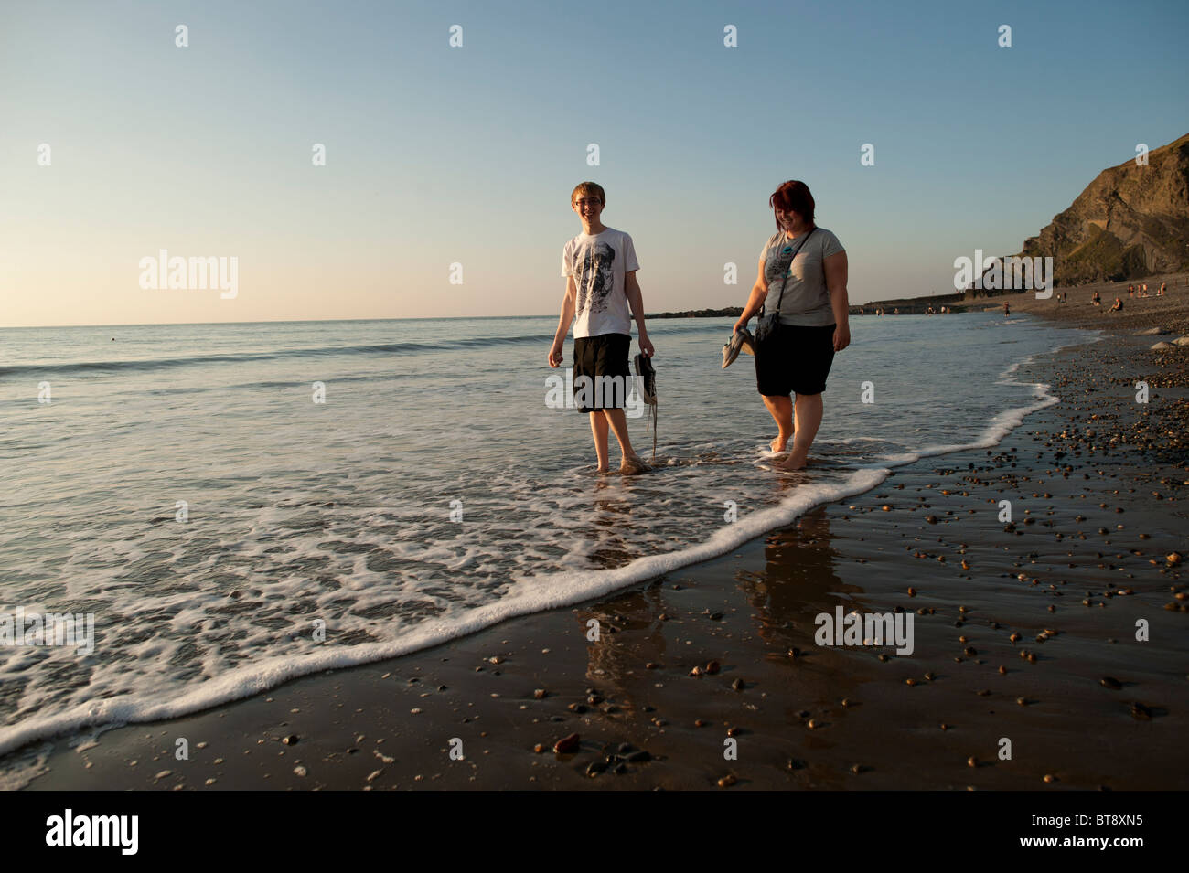 University students paddling in the sea enjoying the unusually warm ...