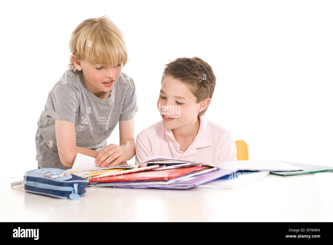 Two children doing their homework Cut Out Stock Images & Pictures - Alamy