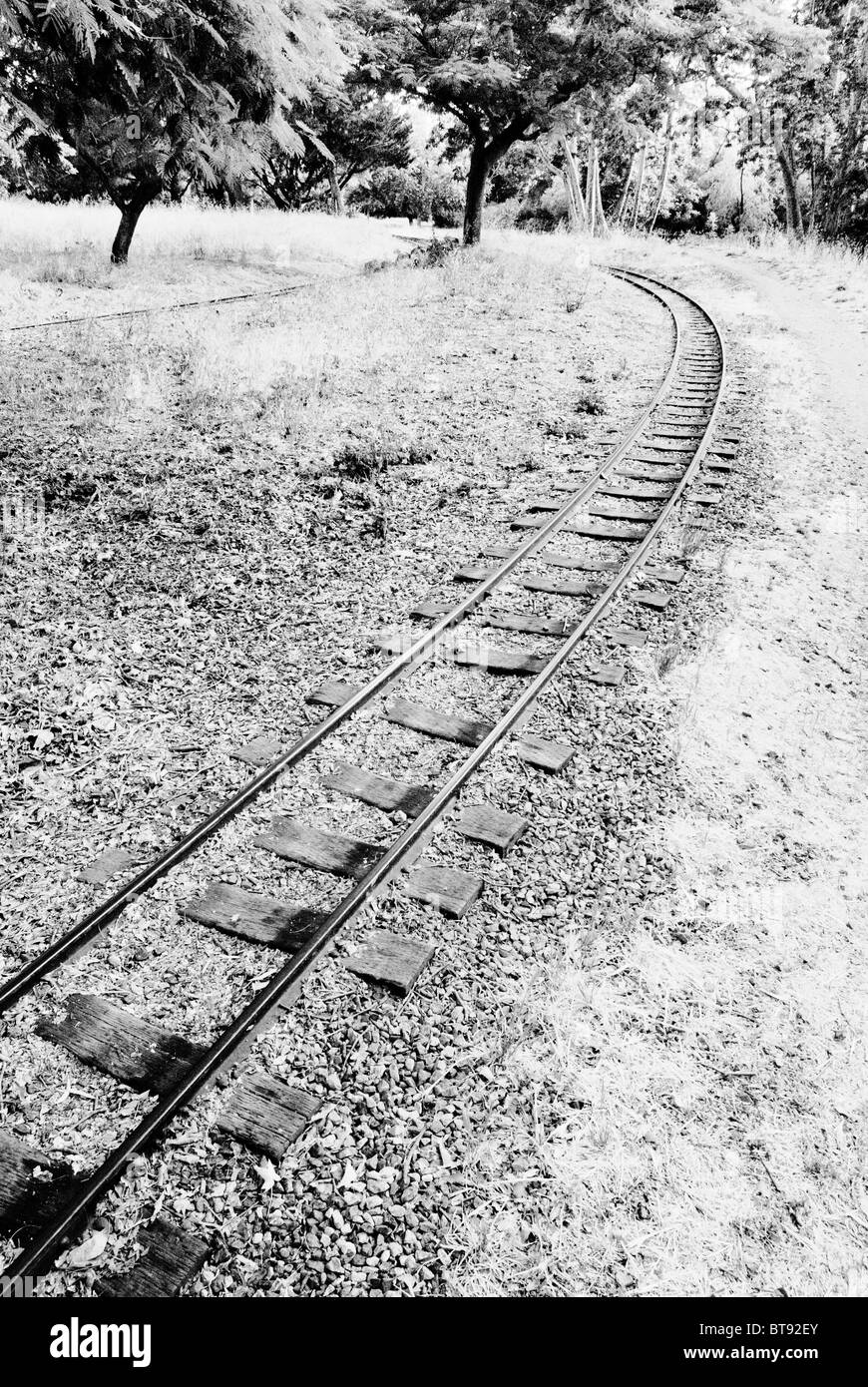 Train tracks bending away at a distance Stock Photo - Alamy