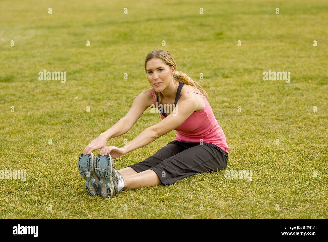 Outdoor spring training exercise in city park showing beautiful young ...