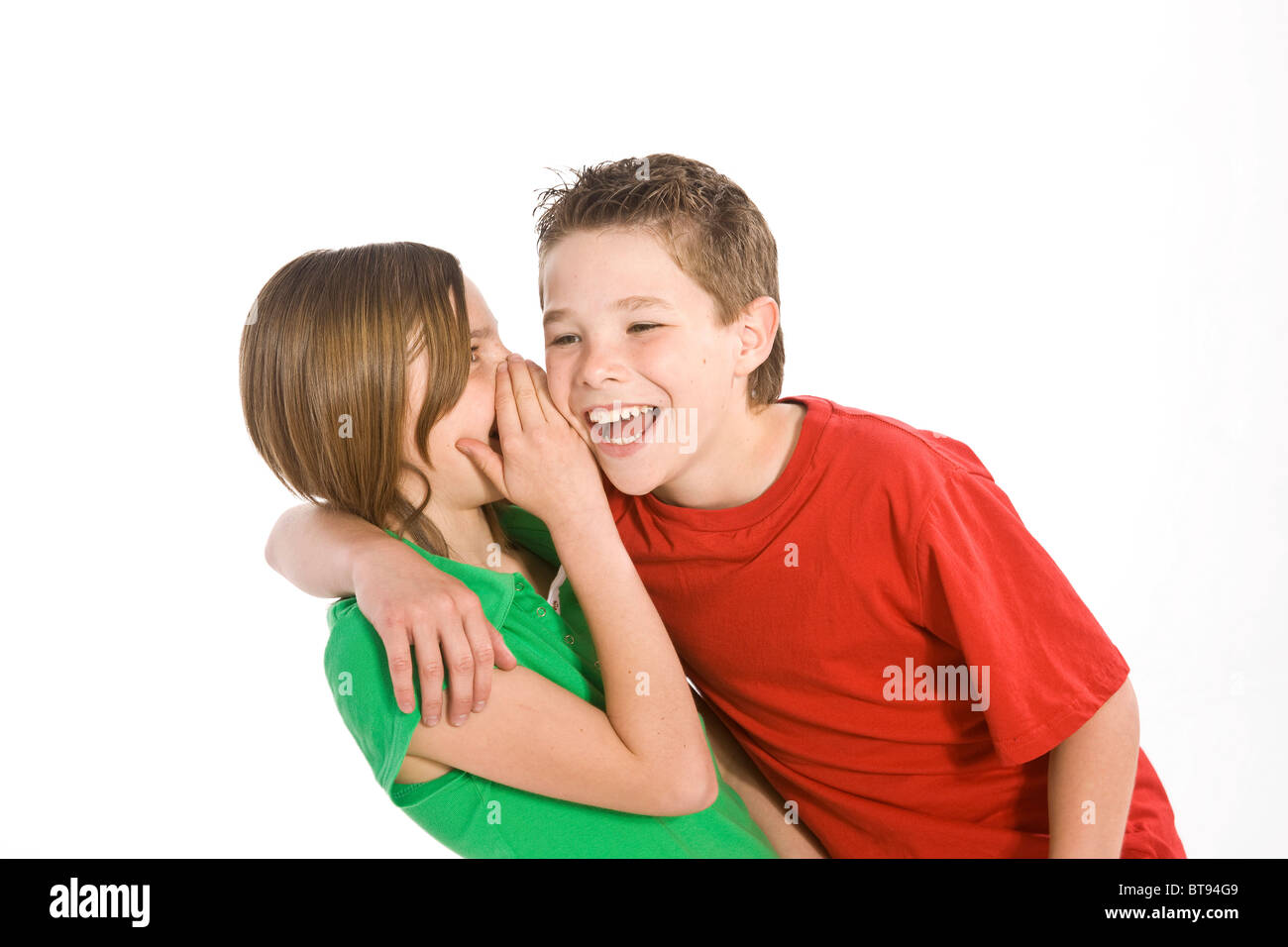 Girl whispering into boys ear hi-res stock photography and images - Alamy
