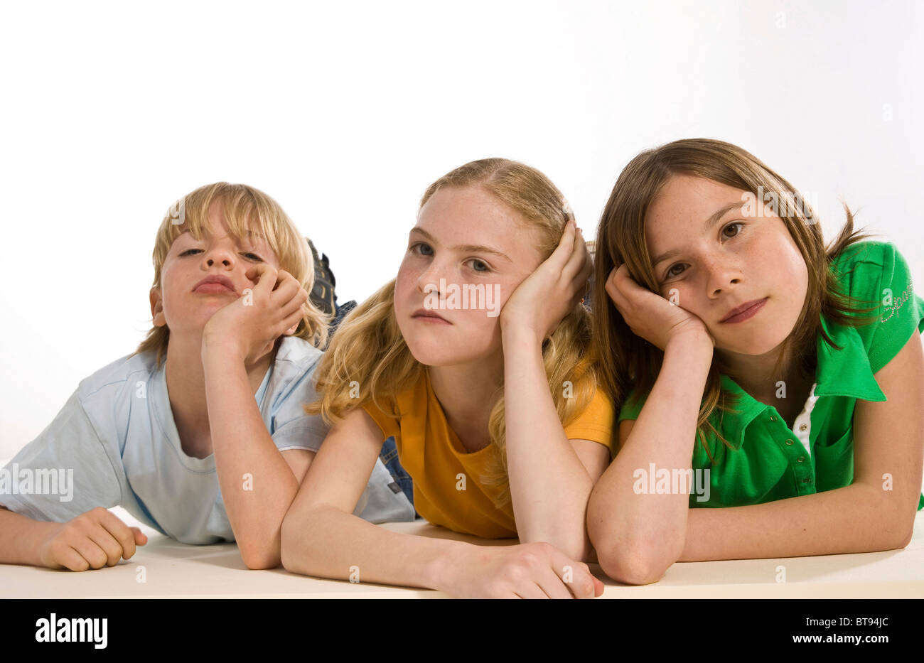 Group of bored children lying on the floor Stock Photo - Alamy
