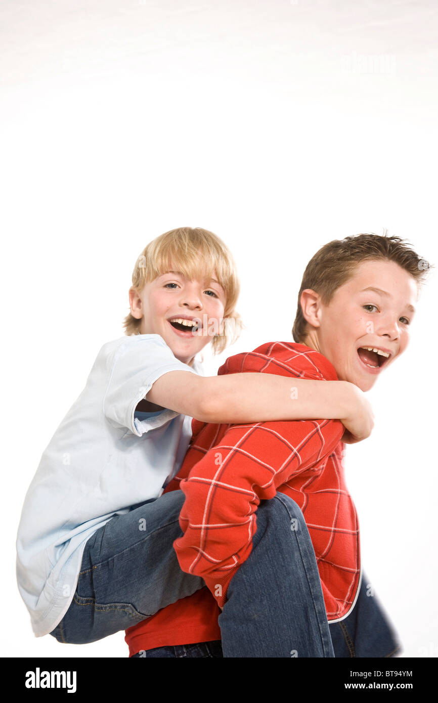 Boy carrying his friend on his back, piggyback Stock Photo - Alamy Boy carrying his friend on his back, piggyback Stock Photo - Alamy