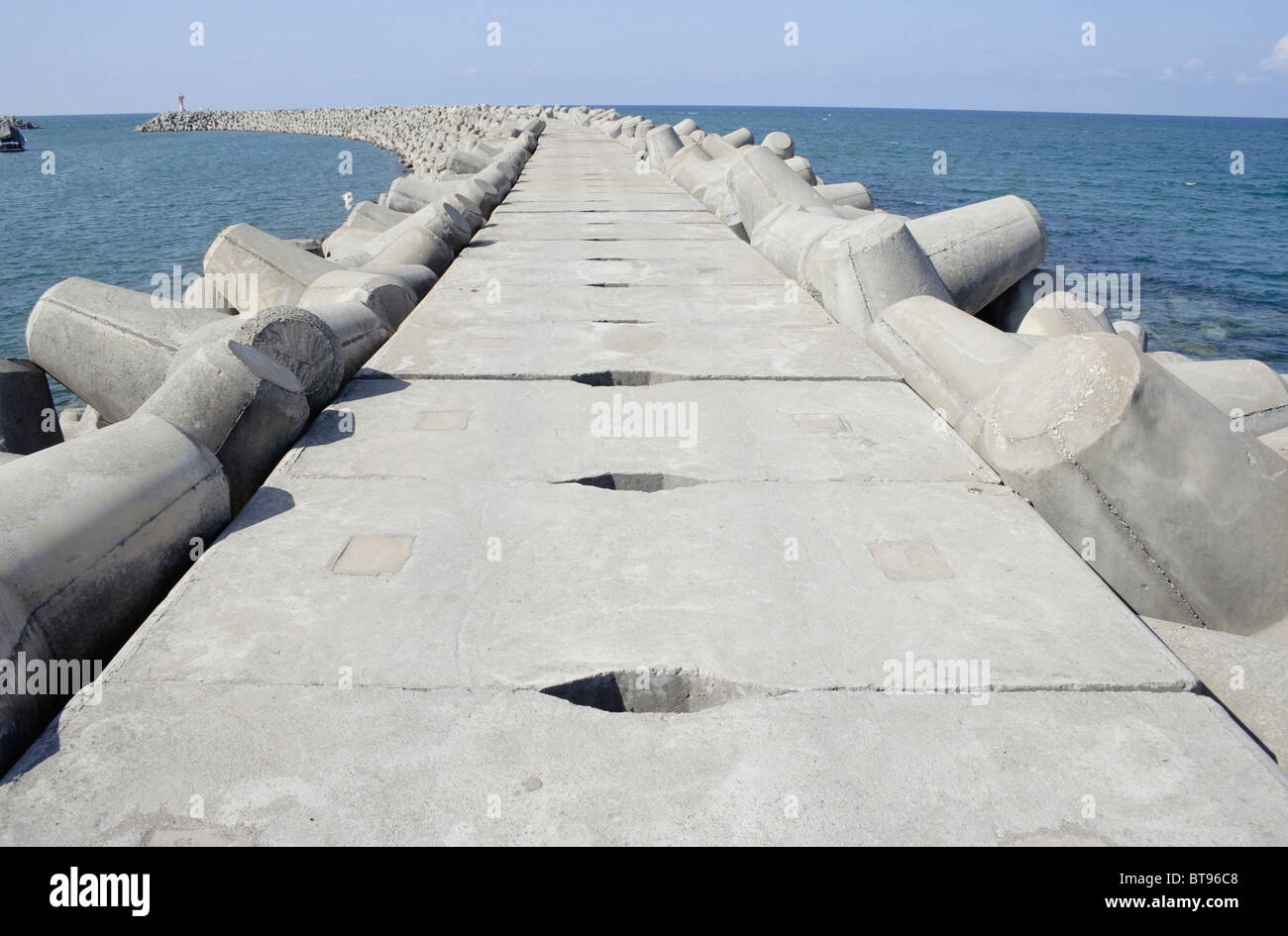 Walkway along tetra concrete block used for wave breaker in Malaysia ...