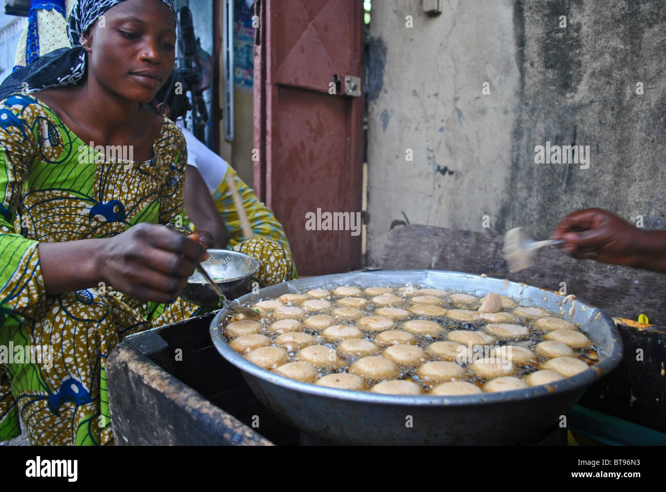 Women prepare deep fried dough balls on a street in Abidjan, Ivory ...