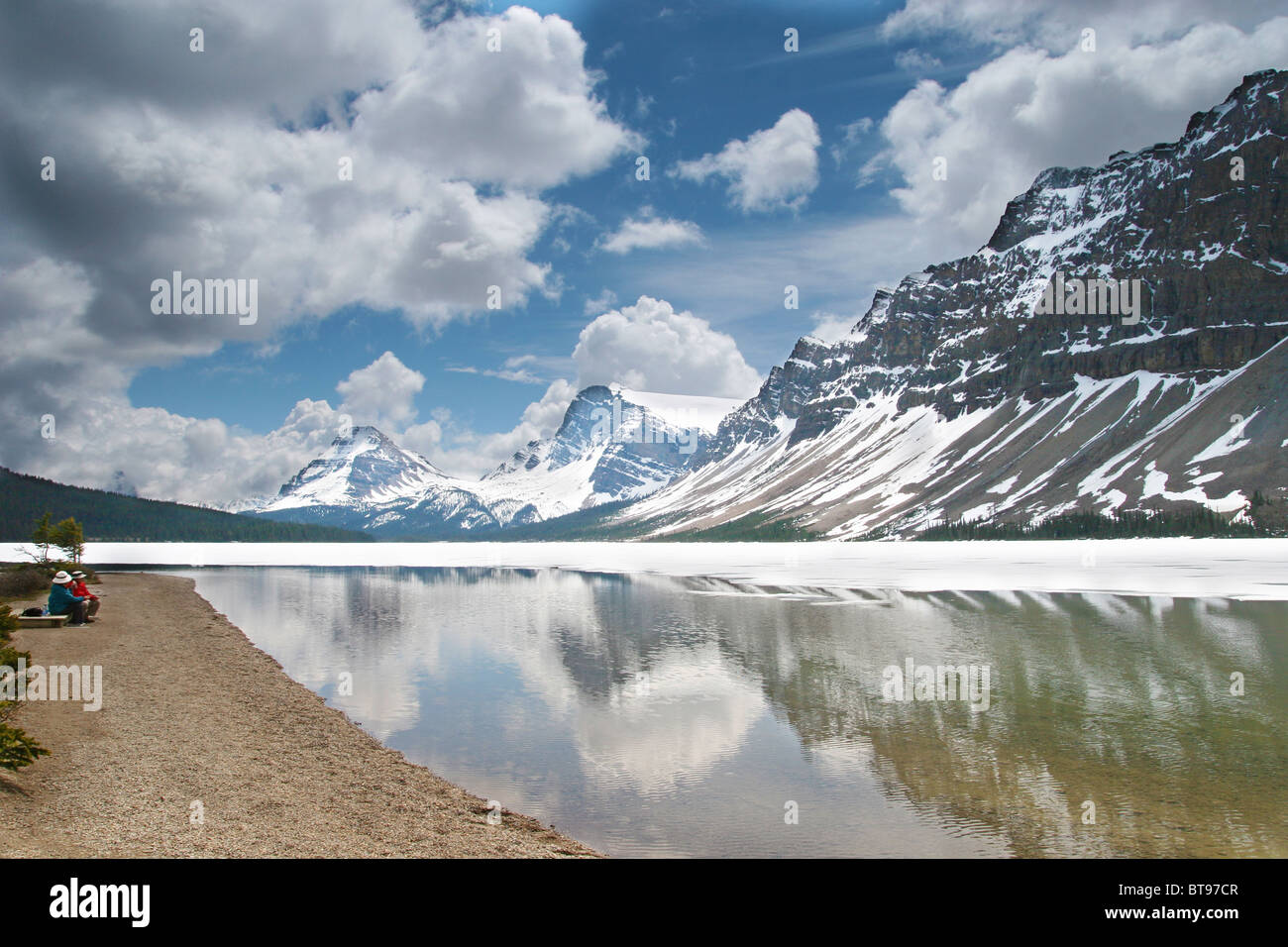 An old couple watching scenic view of the perfect reflection on Bow ...