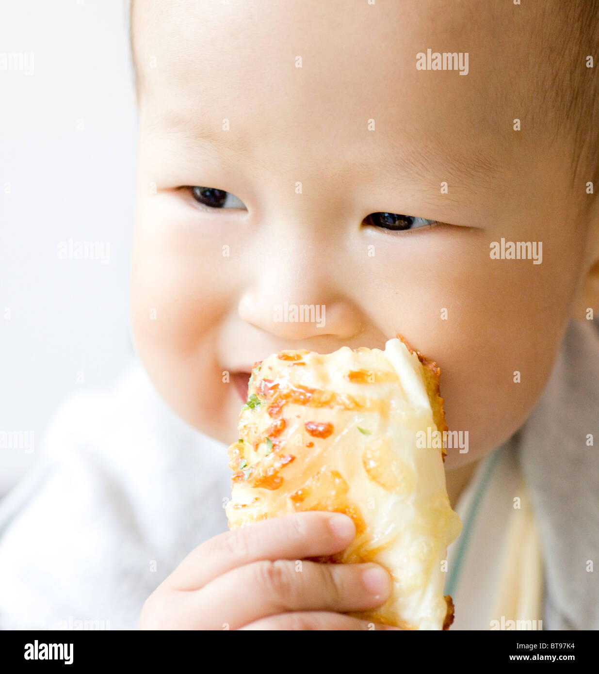 a Asian baby eating the bread Stock Photo - Alamy