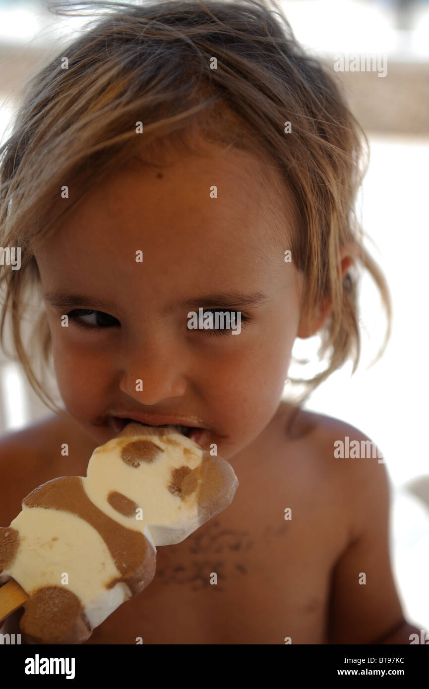 young child eating ice cream in menorca in spain Stock Photo - Alamy