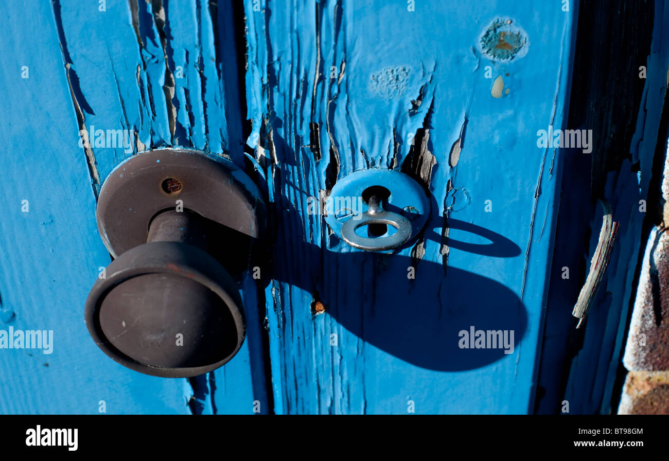 A door knob, and a key in a keyhole on a external wooden door Stock ...