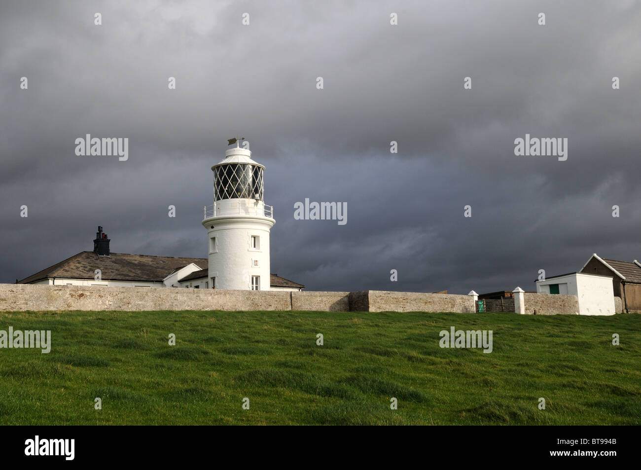 Dramatic stormy sky over St Bees Head Lighthouse Fleswick Bay Cumbria ...