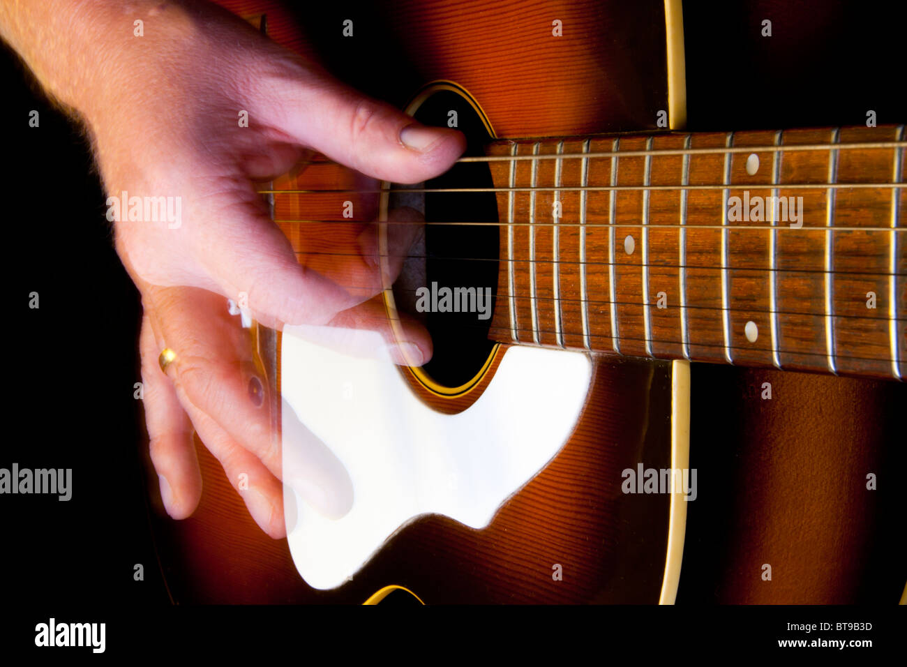 hand playing guitar showing movement Stock Photo - Alamy