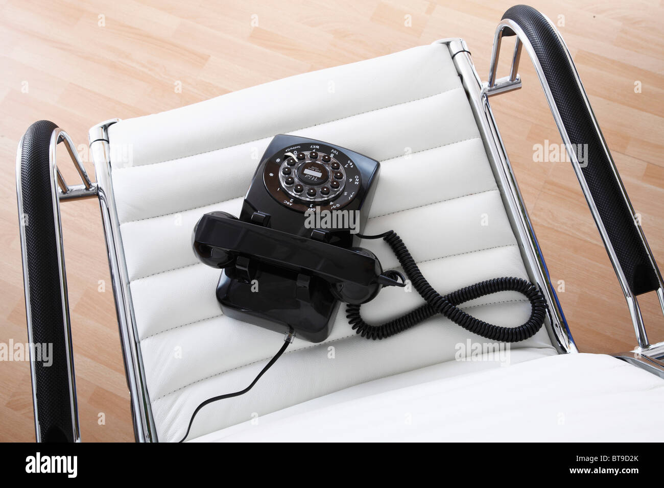 Office chair with an old telephone Stock Photo - Alamy