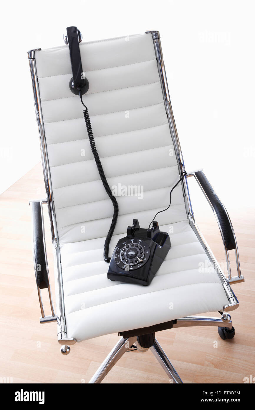 Office chair with an old telephone Stock Photo - Alamy