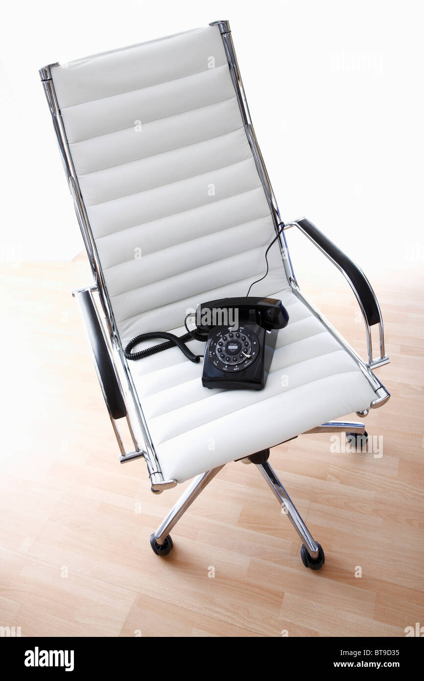 Office chair with an old telephone Stock Photo - Alamy