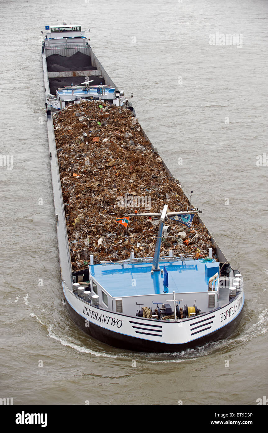 Commercial barge hauling scrap metal and palverised coal, river Rhine ...