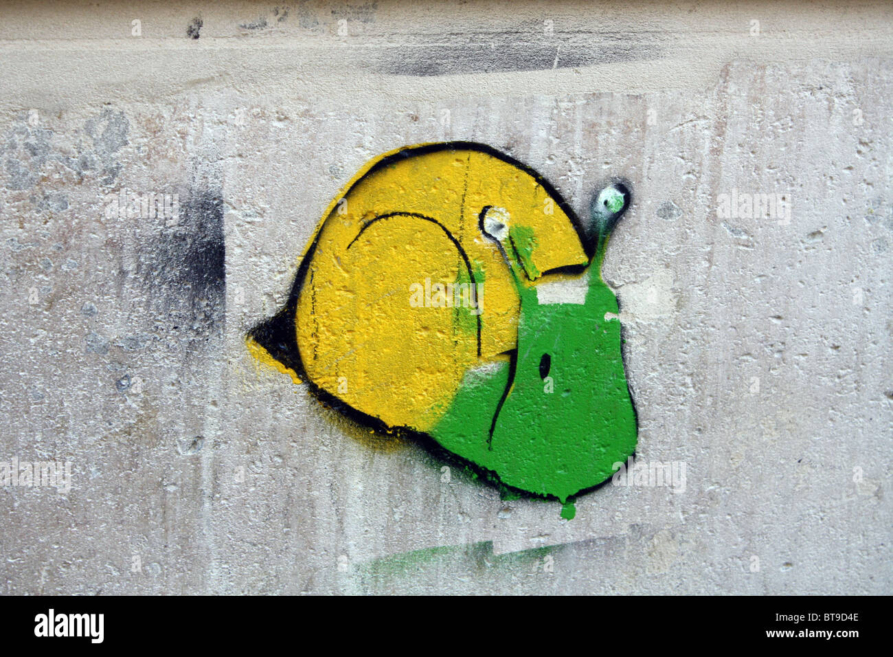 Green and Yellow Snail Graffiti on a wall Stock Photo - Alamy