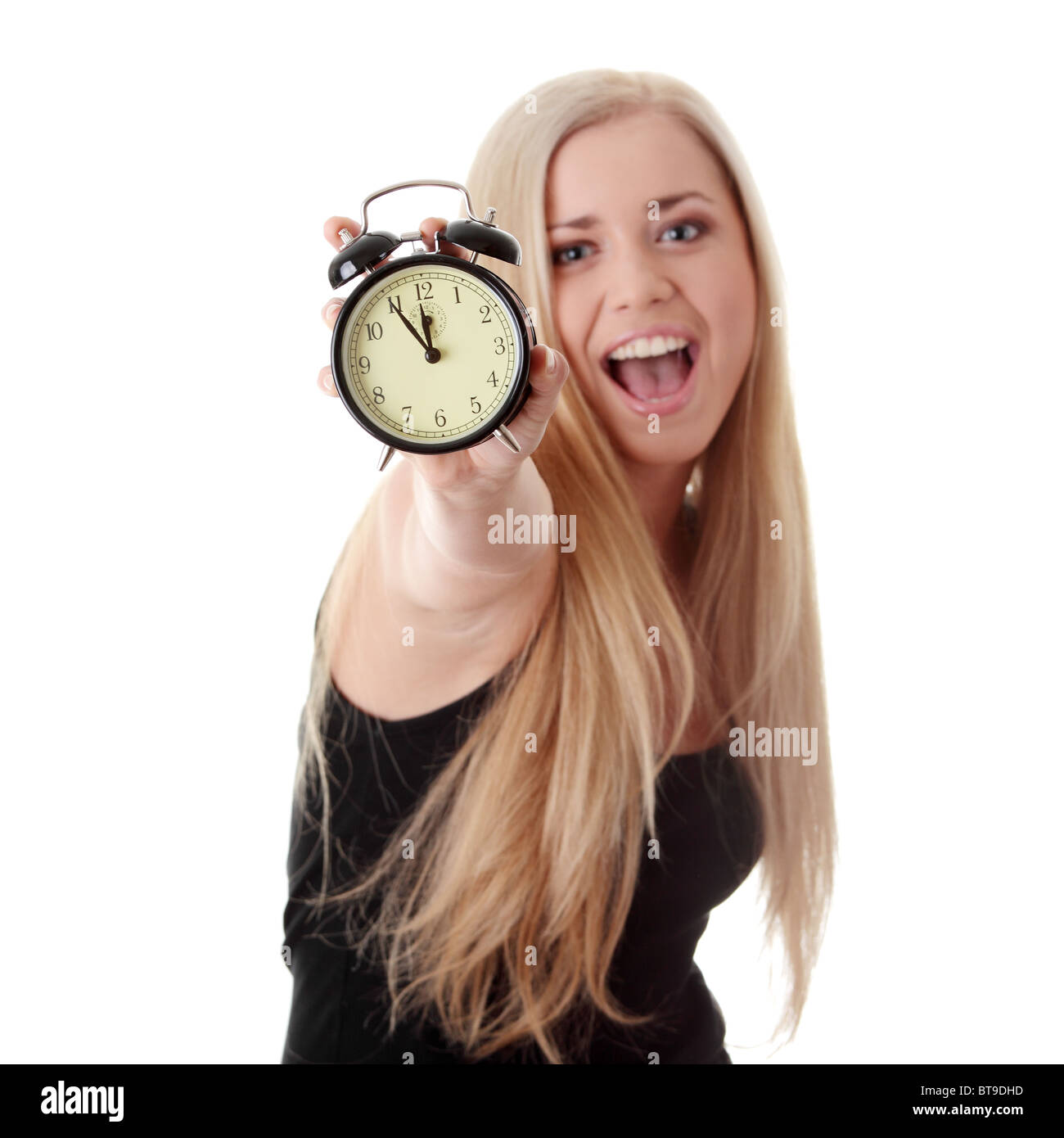 Young blond woman showing alarm clock, isolated on white Stock Photo ...