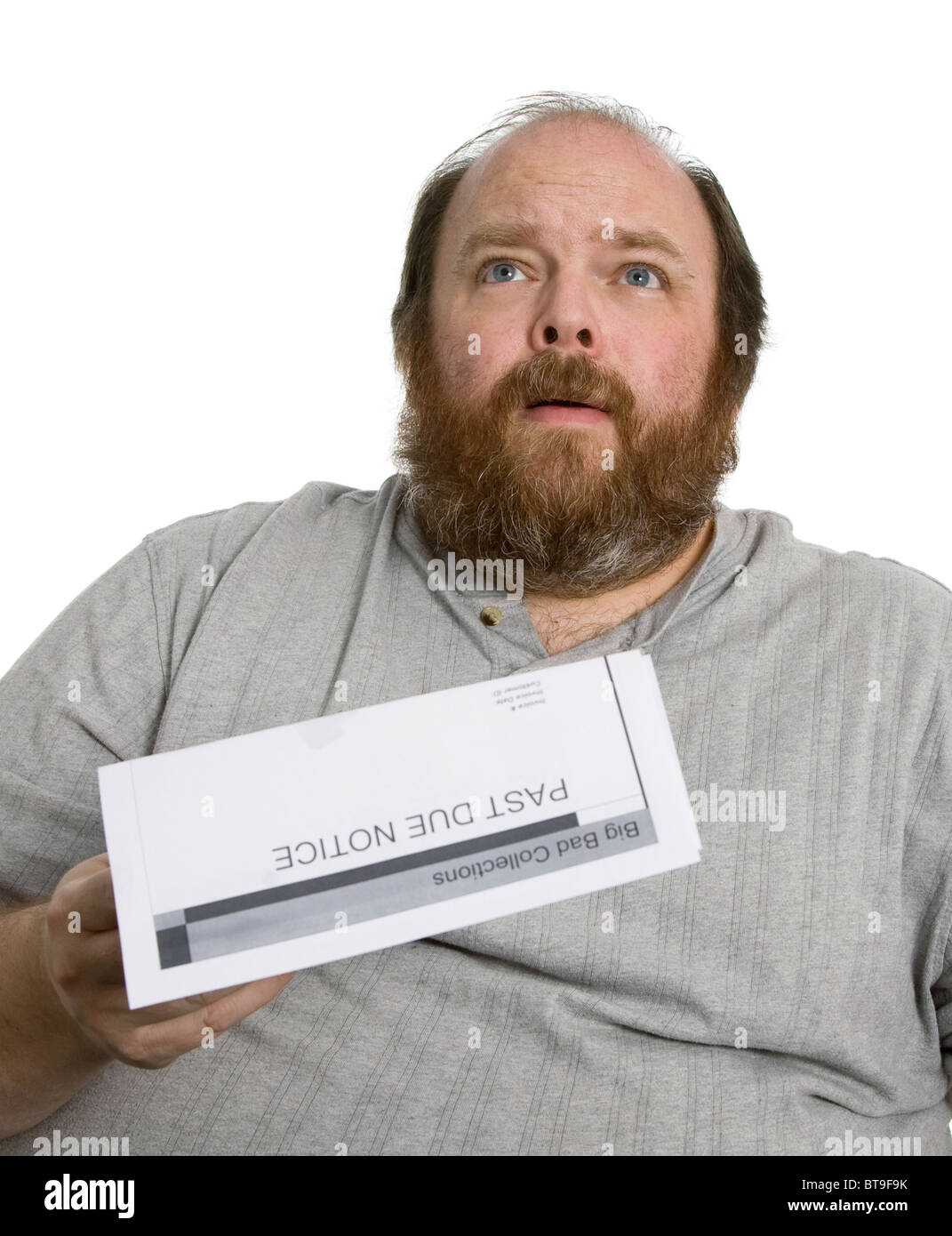 Man holding a past due notice and looking very worried Stock Photo - Alamy
