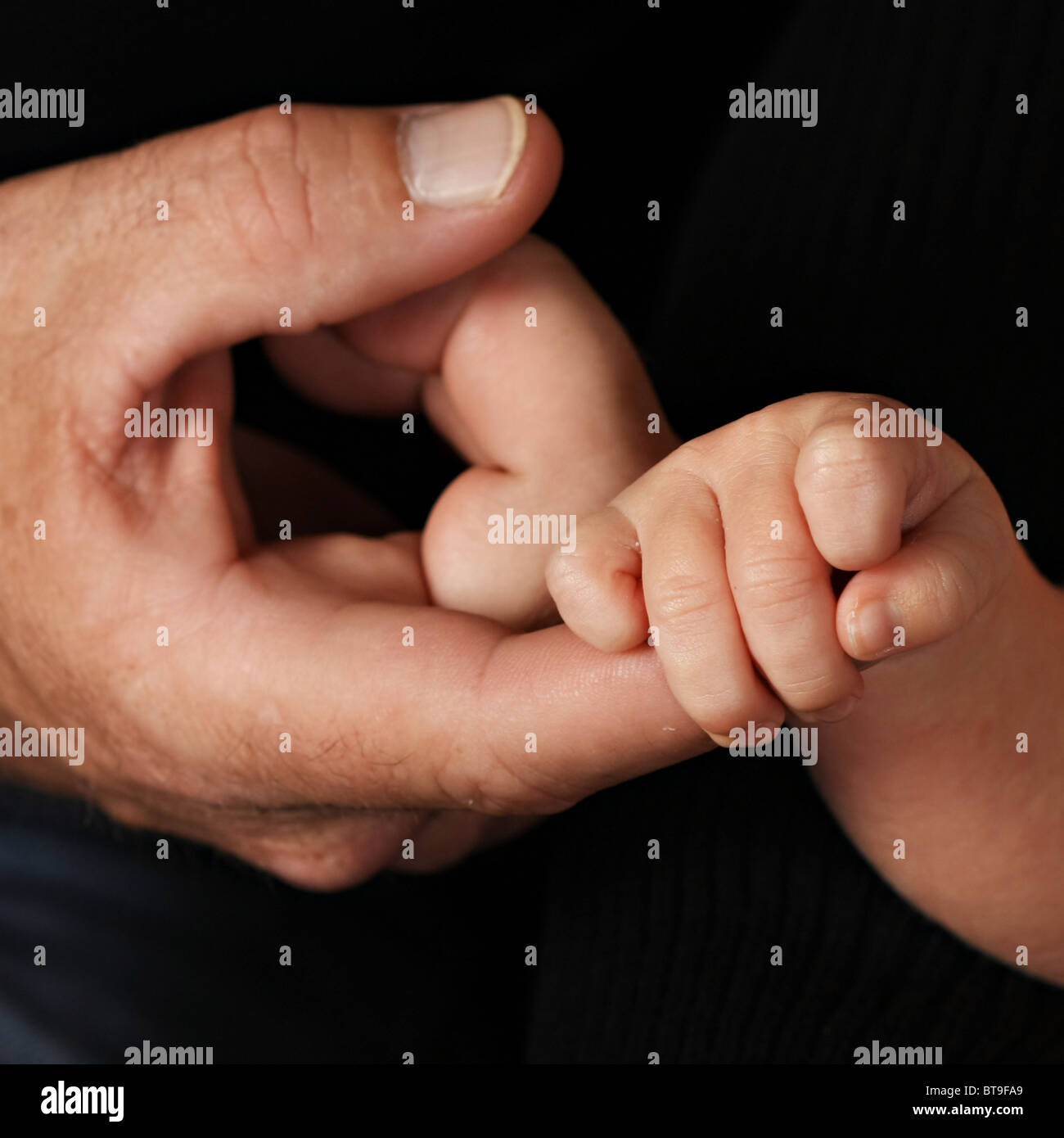 A young infant hand in hand with father Stock Photo - Alamy