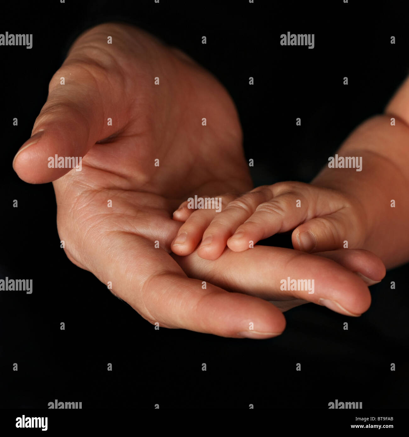 A young infant hand in hand with father Stock Photo - Alamy