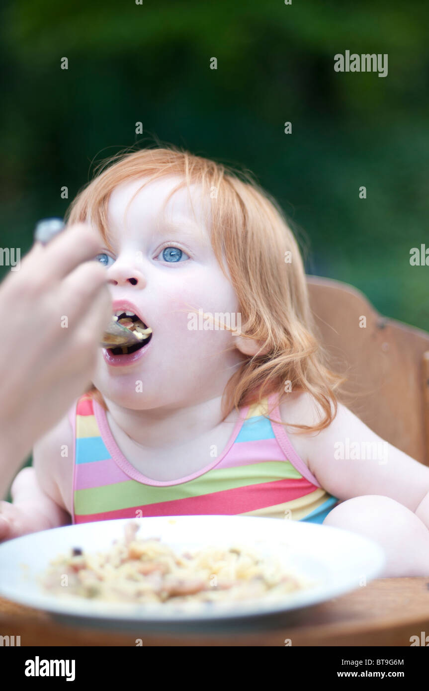 A young child being fed Stock Photo - Alamy