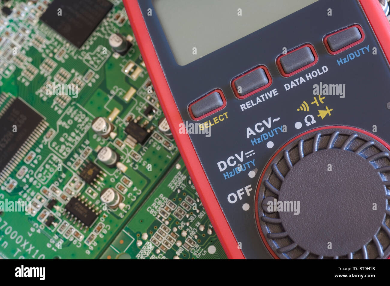 Electronic multimeter measuring device on top of electronic circuitry ...