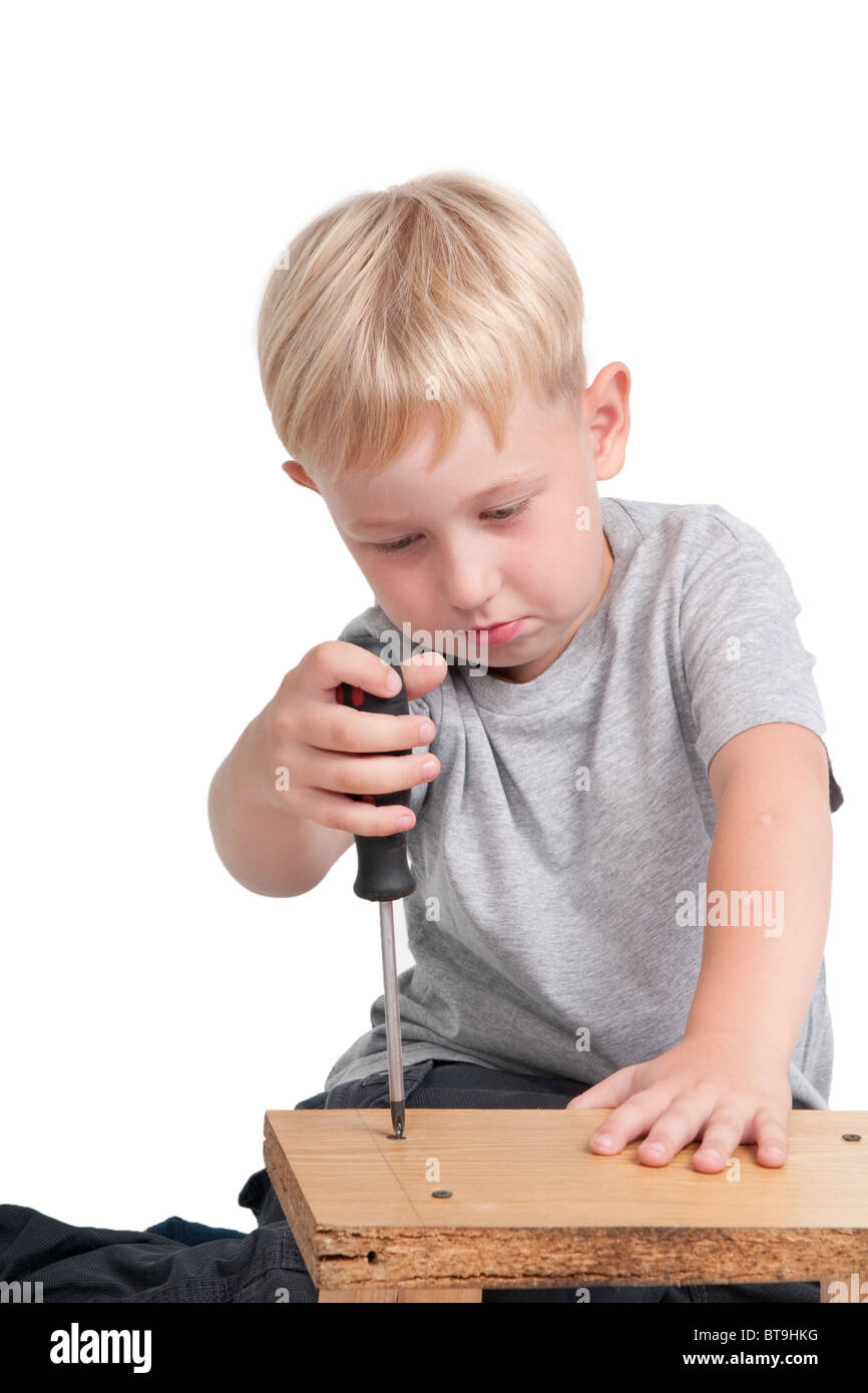 Seven years old boy using a screw-driver Stock Photo - Alamy